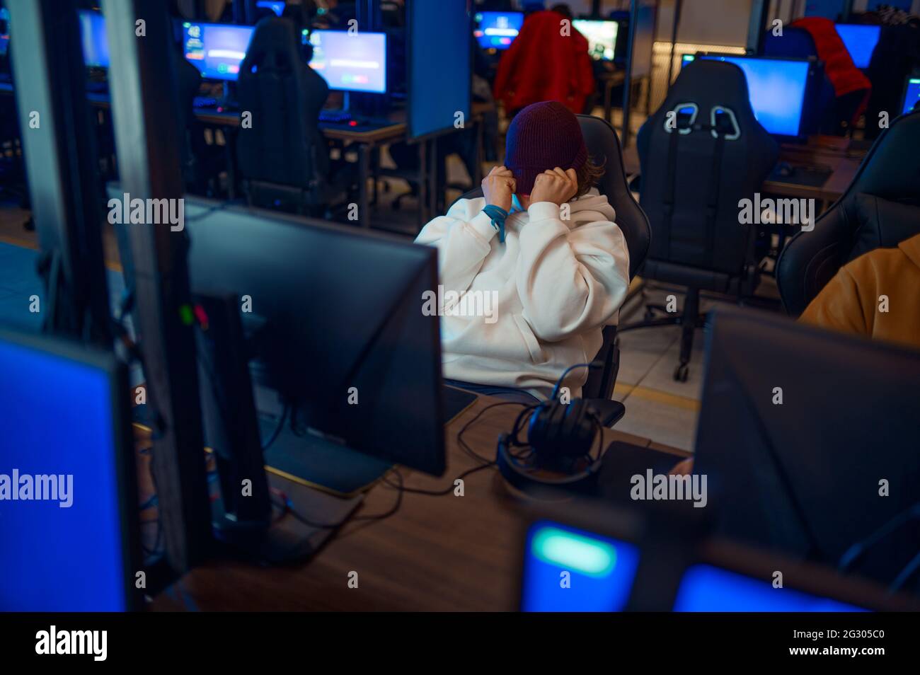 Young gamer staring at the monitor, game club Stock Photo - Alamy