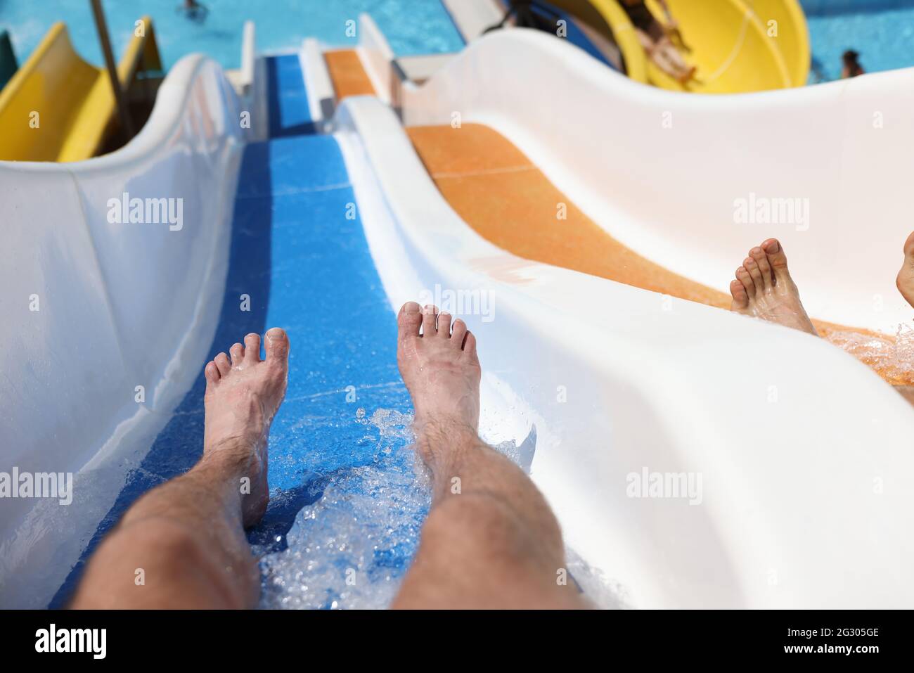 Male feet on slide in a water park while descending Stock Photo - Alamy