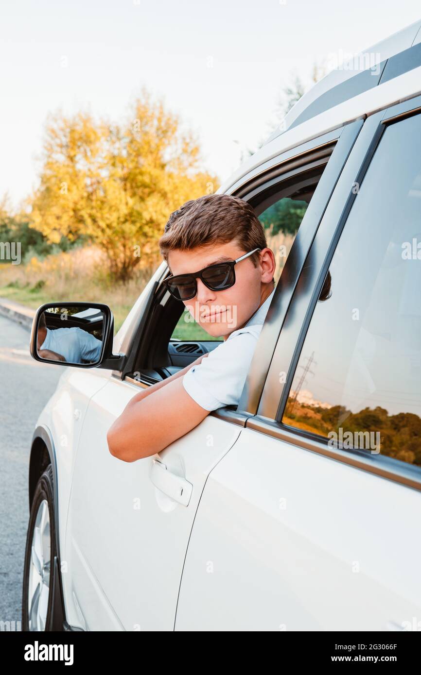 young handsome confident man driving car. road trip Stock Photo - Alamy