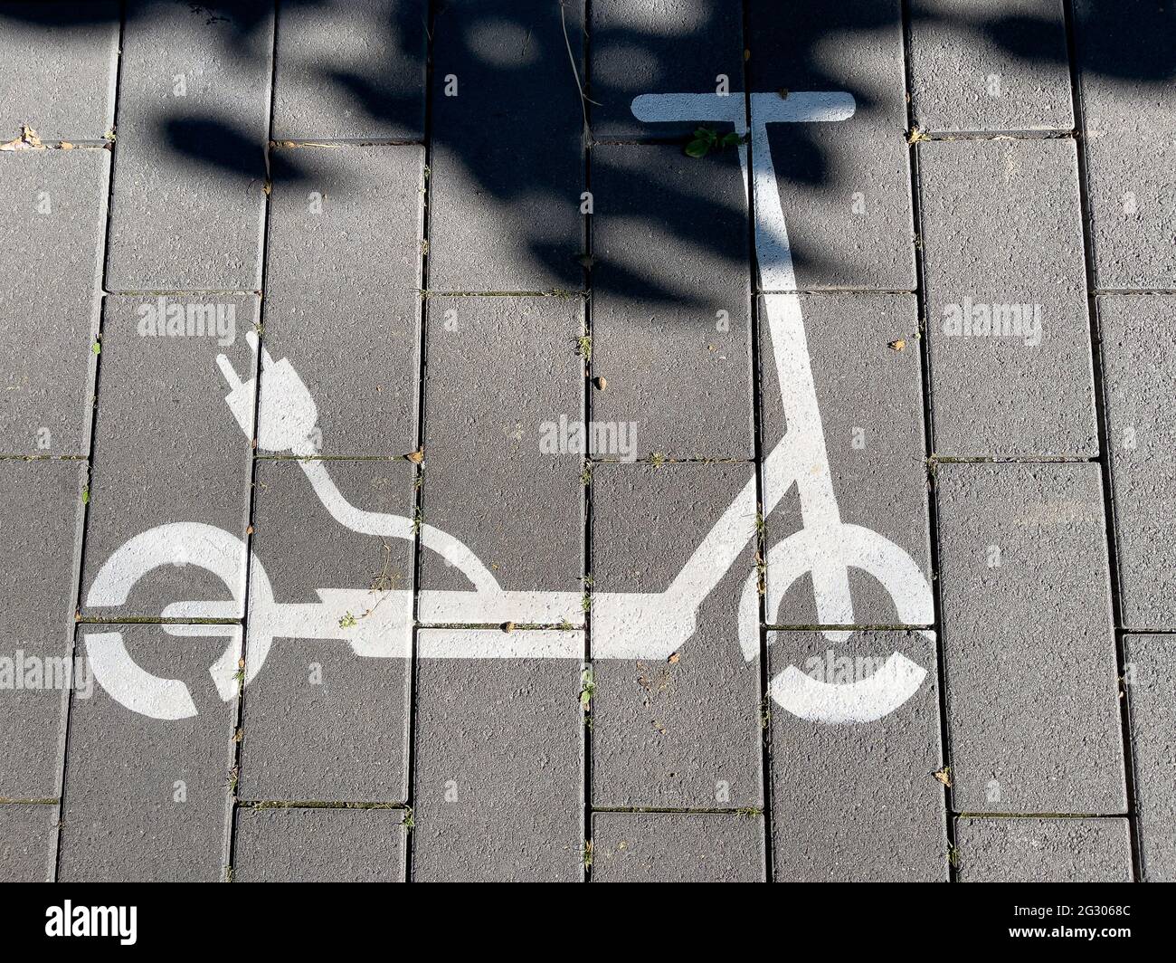 A view of a street. Electric scooter charging station, symbol on the ...