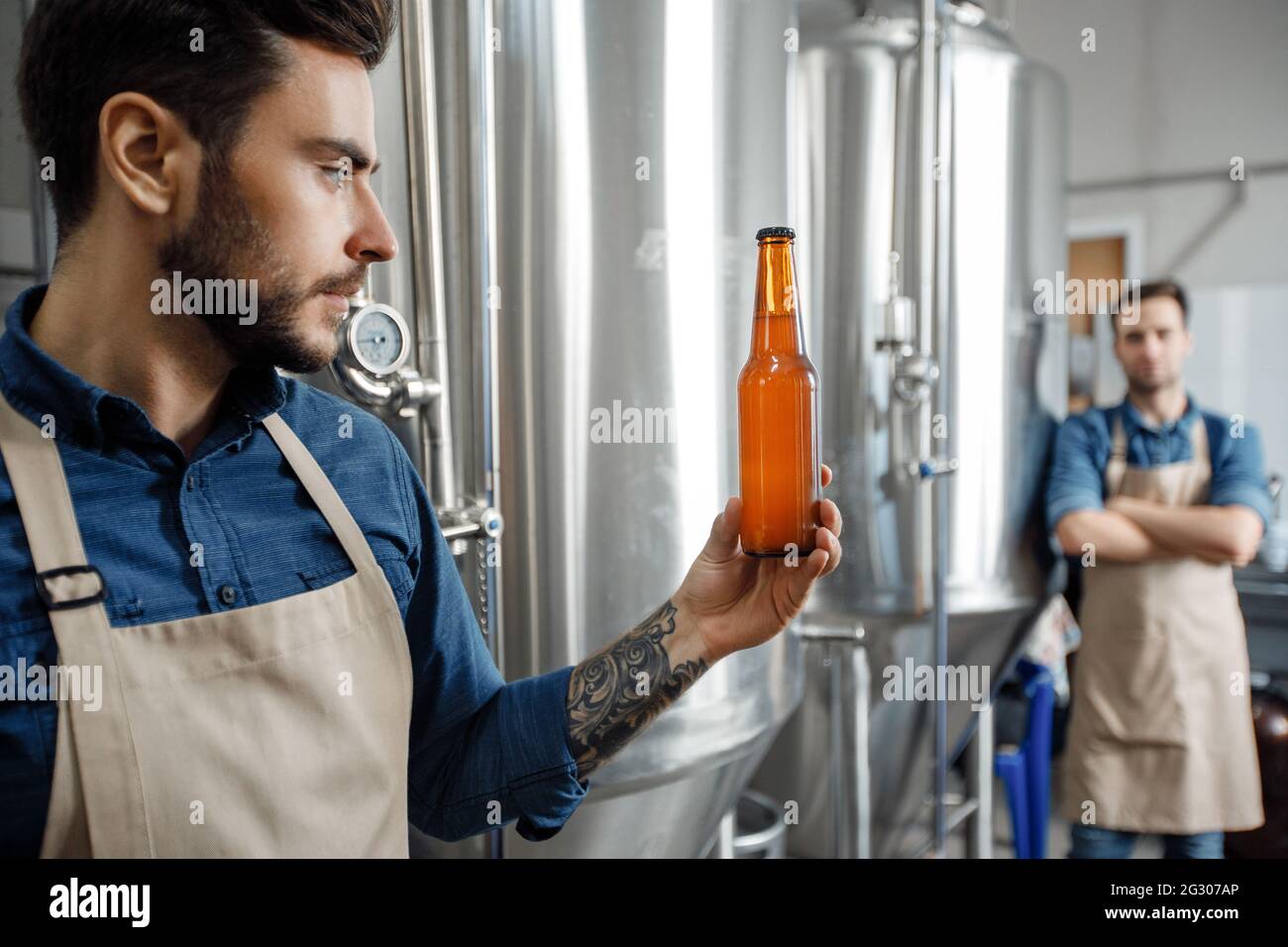 Small business and modern brewery. Owners check quality of drink Stock ...