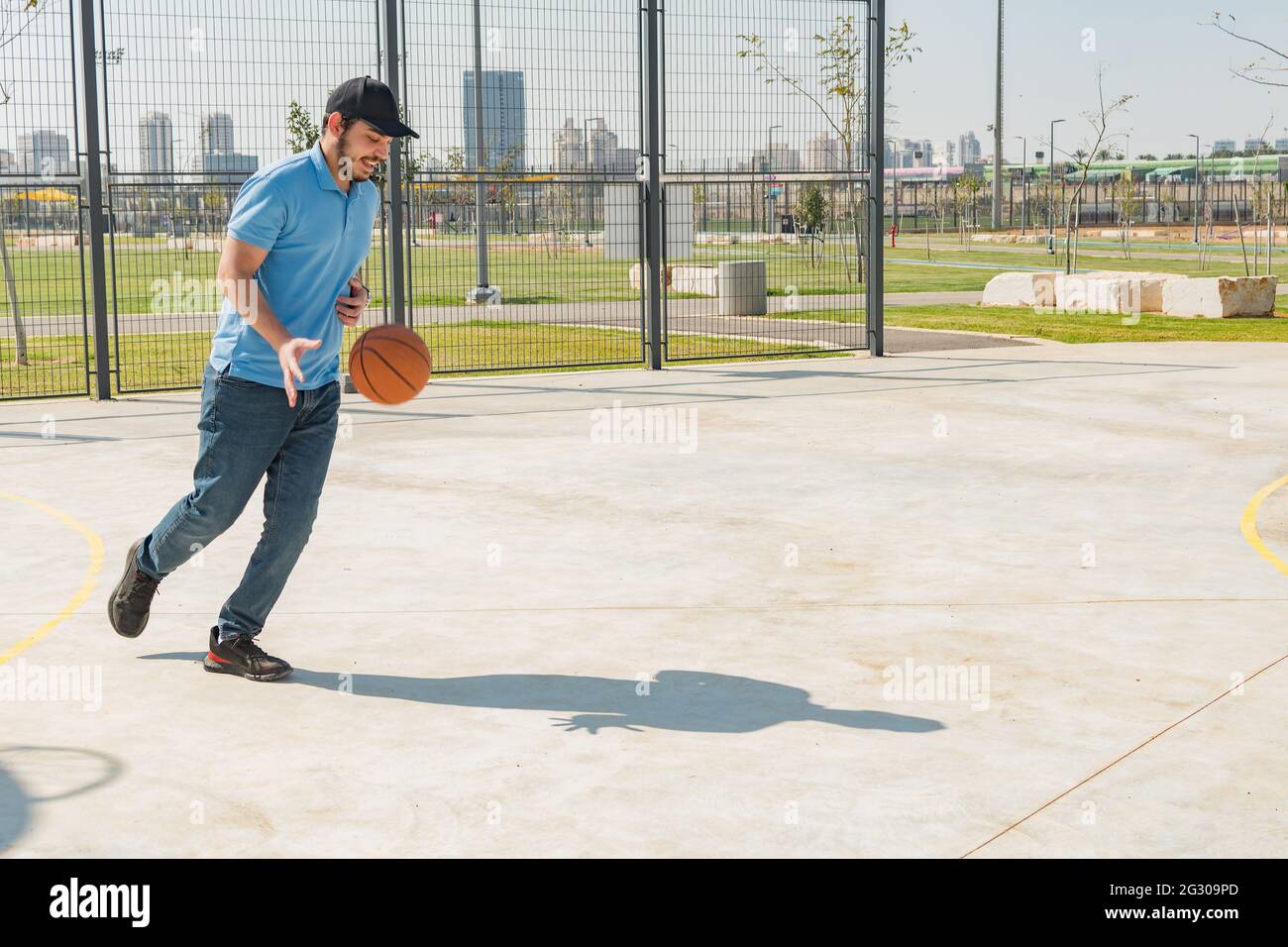 A sporty guy playing basketball outdoor Stock Photo - Alamy