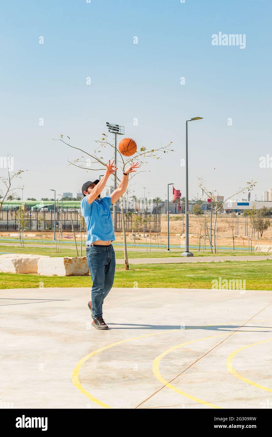 A sporty guy playing basketball outdoor Stock Photo - Alamy
