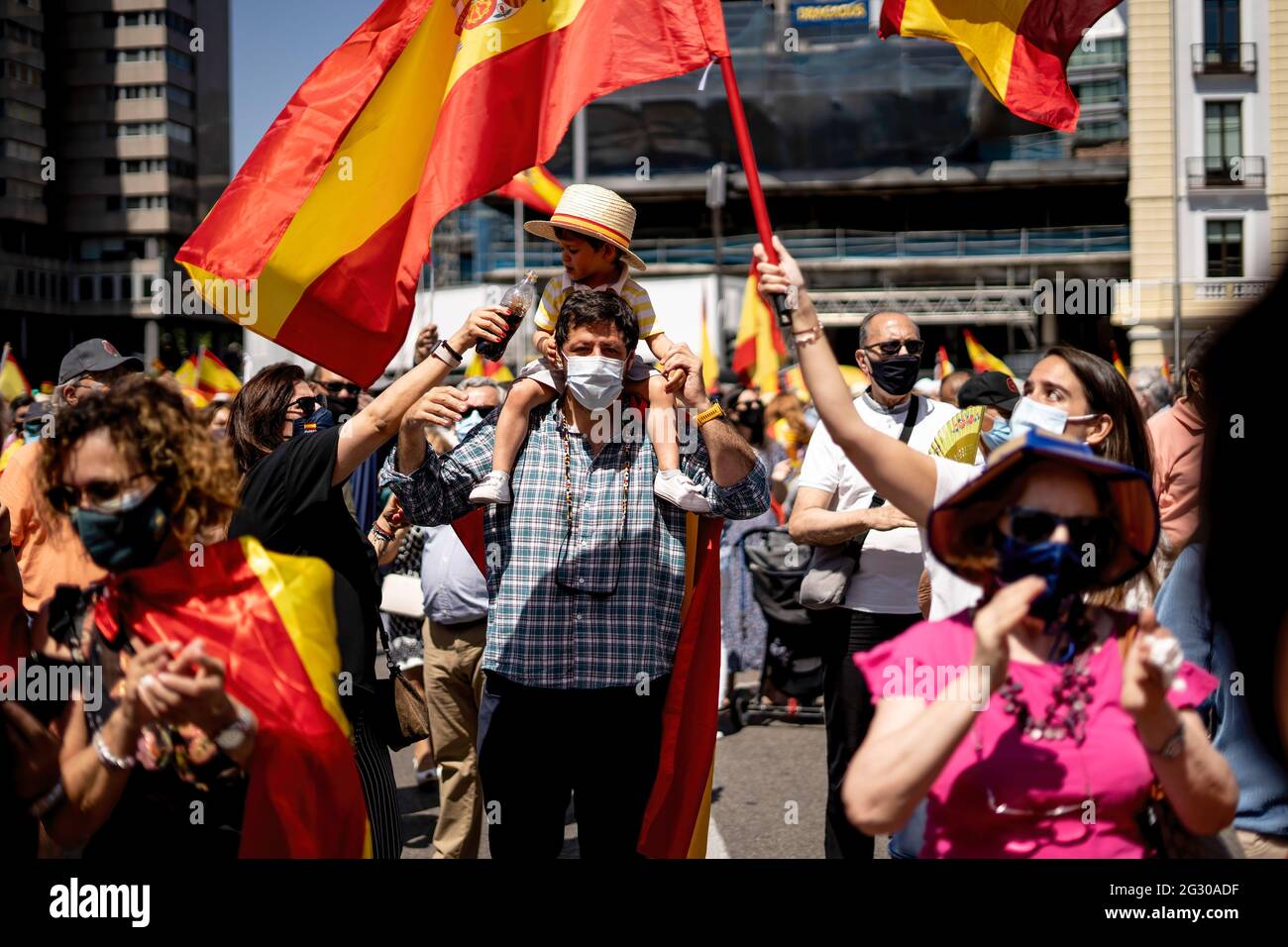 Madrid, Spain. 13th June, 2021. A man carries his son on his shoulders ...