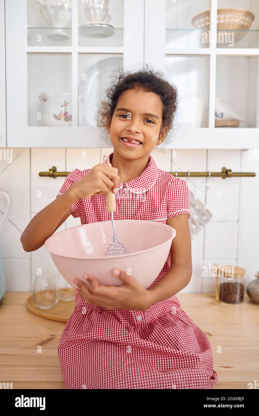 Little girl cooking the dough, nice breakfast Stock Photo - Alamy