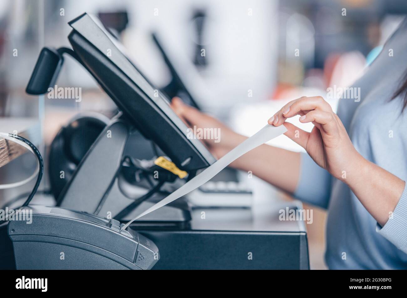 Saleswoman printing invoice or receipt for a customer in the shopping ...