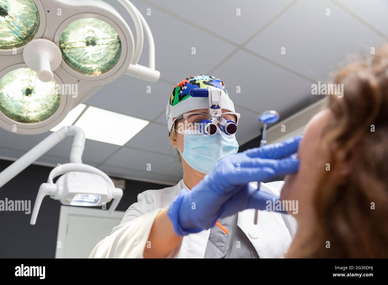 Dentist working on a patient in dental clinic Stock Photo - Alamy