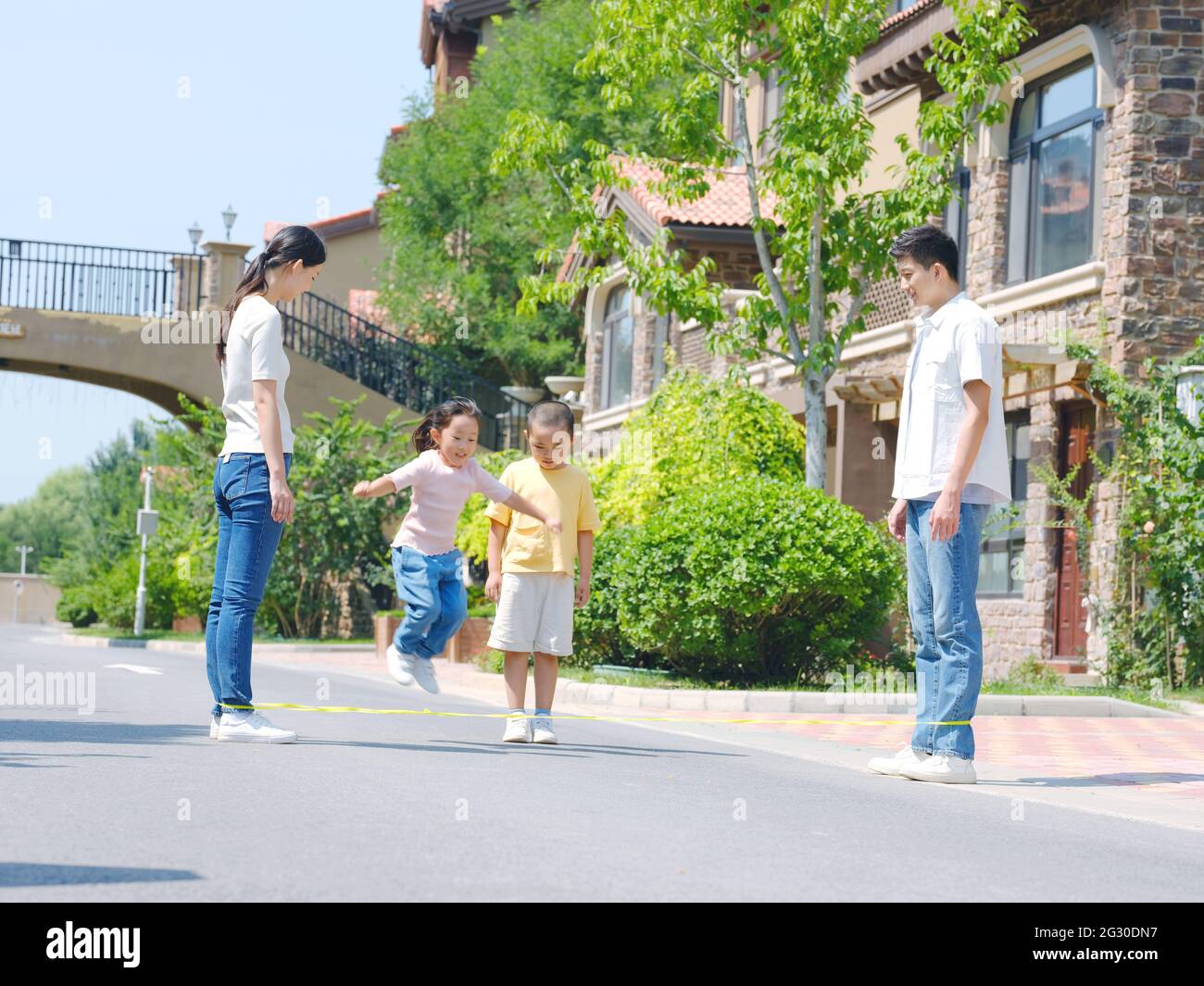 Happy family of four skipping rope outdoors high quality photo Stock ...