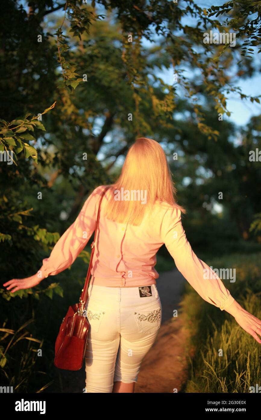 A person standing next to a tree Stock Photo - Alamy