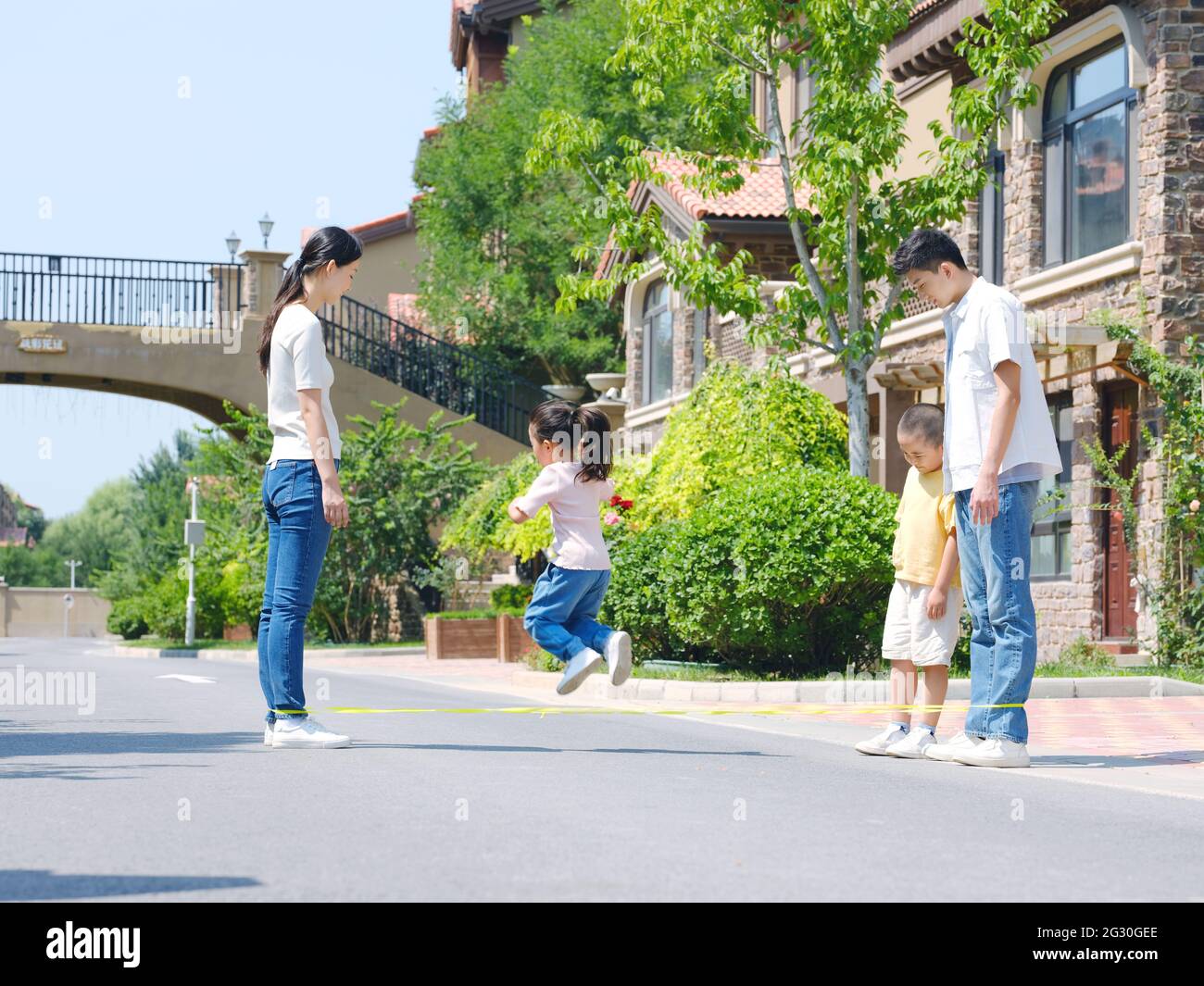 Happy family of four skipping rope outdoors high quality photo Stock ...