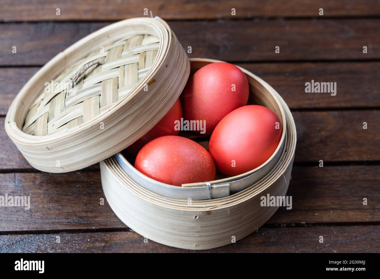 Red color eggs in dim sum tray. Red eggs are served in birthday ...
