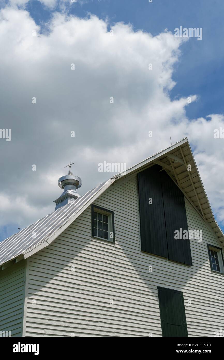 Old white barn with metal roof, windows, and interesting eaves ...