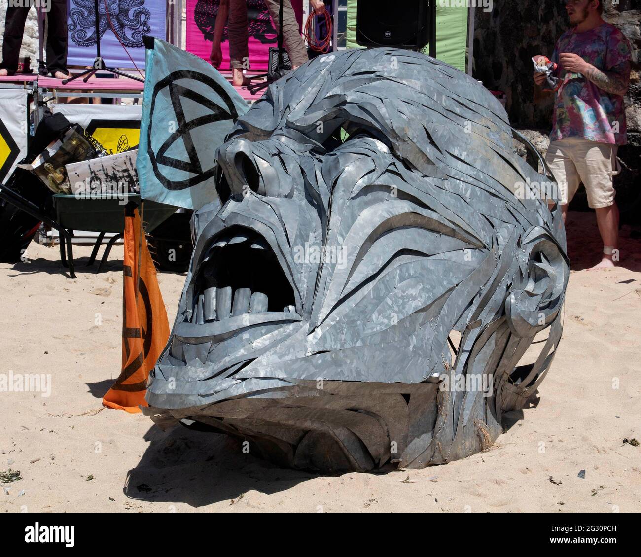 St Ives, Cornwall, UK. 13th June, 2021. A giant sinking head statue is ...