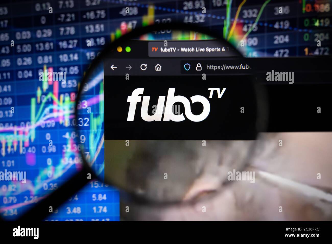 Fubo TV company logo on a website with blurry stock market developments ...