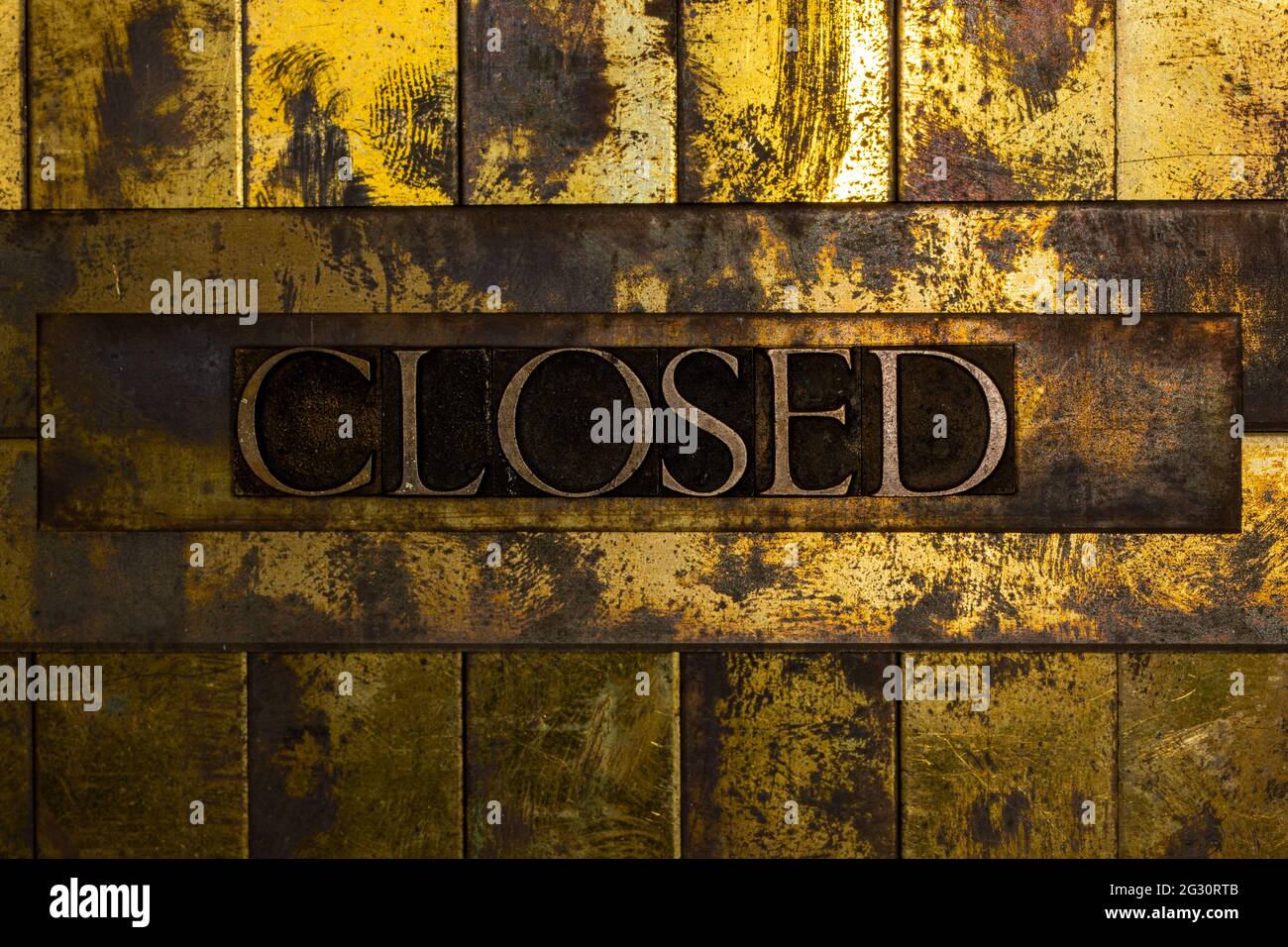 Closed text on textured copper and gold background Stock Photo - Alamy