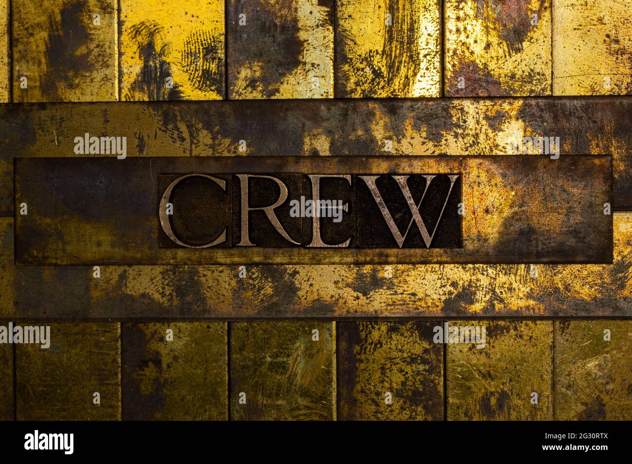 Crew text on textured copper and gold background Stock Photo - Alamy