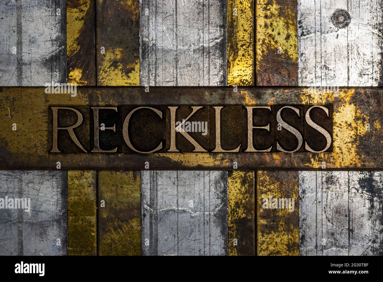 Reckless text on textured grunge copper and vintage gold background ...