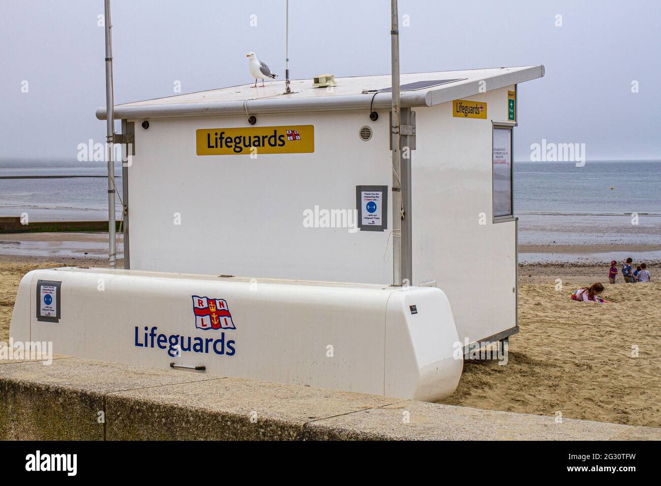 RNLI lifeguard station keeping watch on the beach at Lyme Regis, Dorset ...