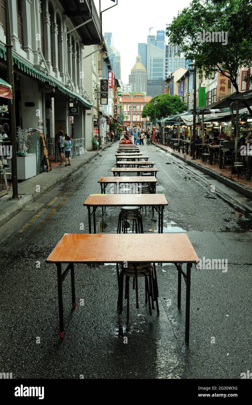 Long line of tables stretching down the centre of a narrow street ...