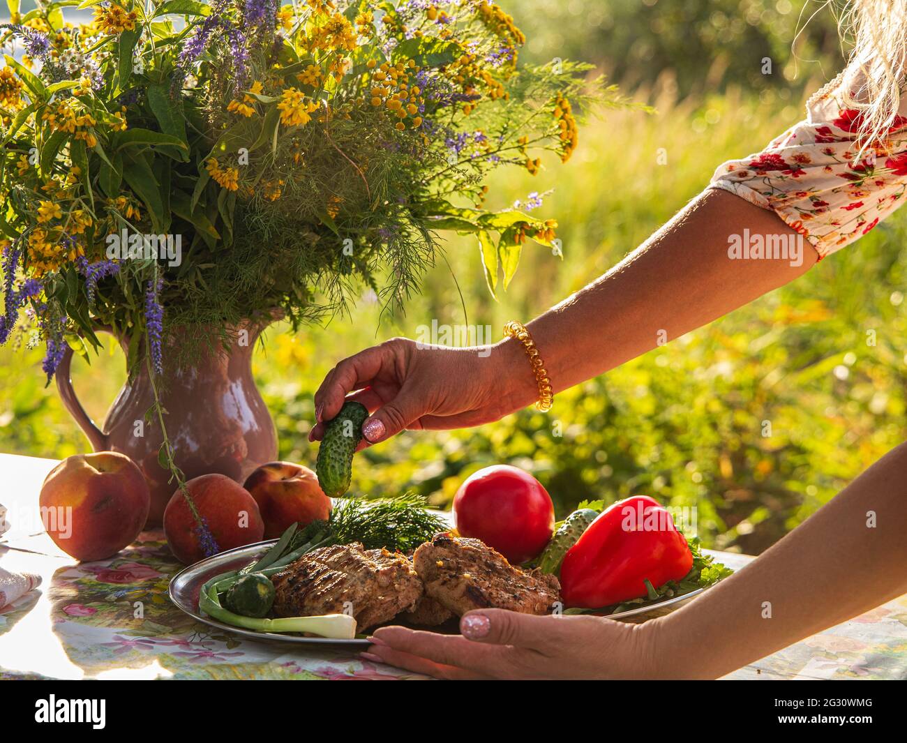 Still life outdoor with barbecue and bouquet wildflowers Stock Photo ...