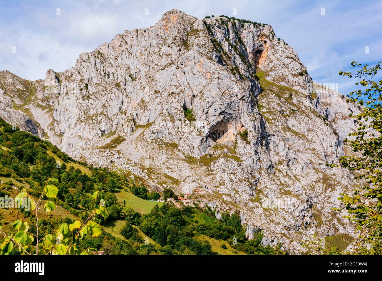 Bulnes de Arriba, El Castillo, under a great mountain of limestone rock ...