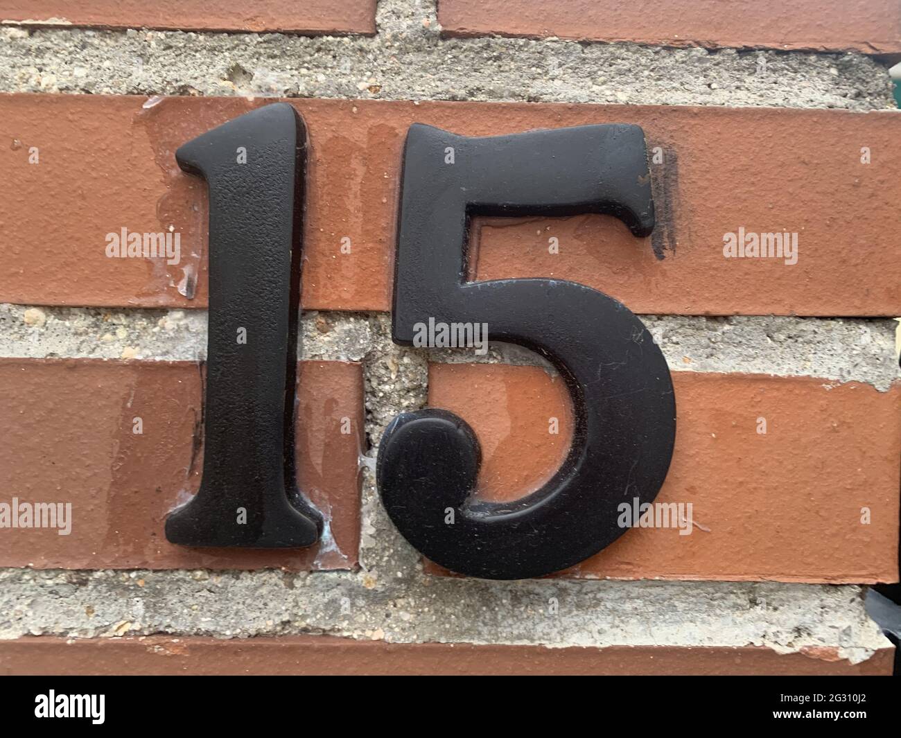 A closeup shot of number "15" in the address on the building wall Stock ...