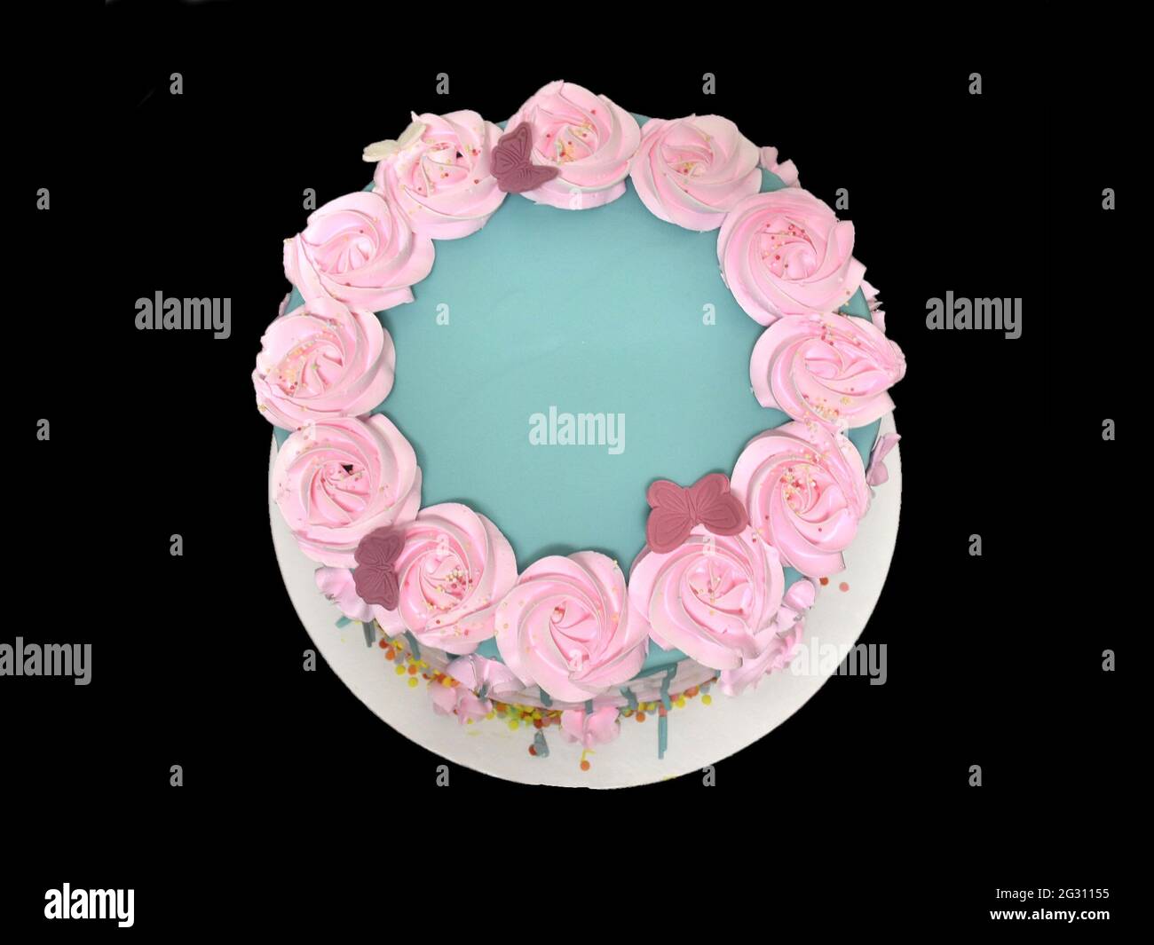 An overhead shot of a birthday cake with pink flowers and butterflies ...