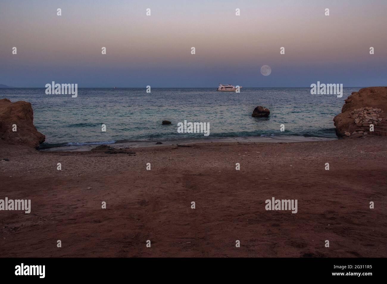 Full moon over the Red Sea Stock Photo - Alamy