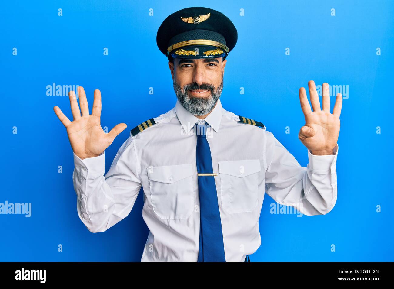 Middle age man with beard and grey hair wearing airplane pilot uniform ...