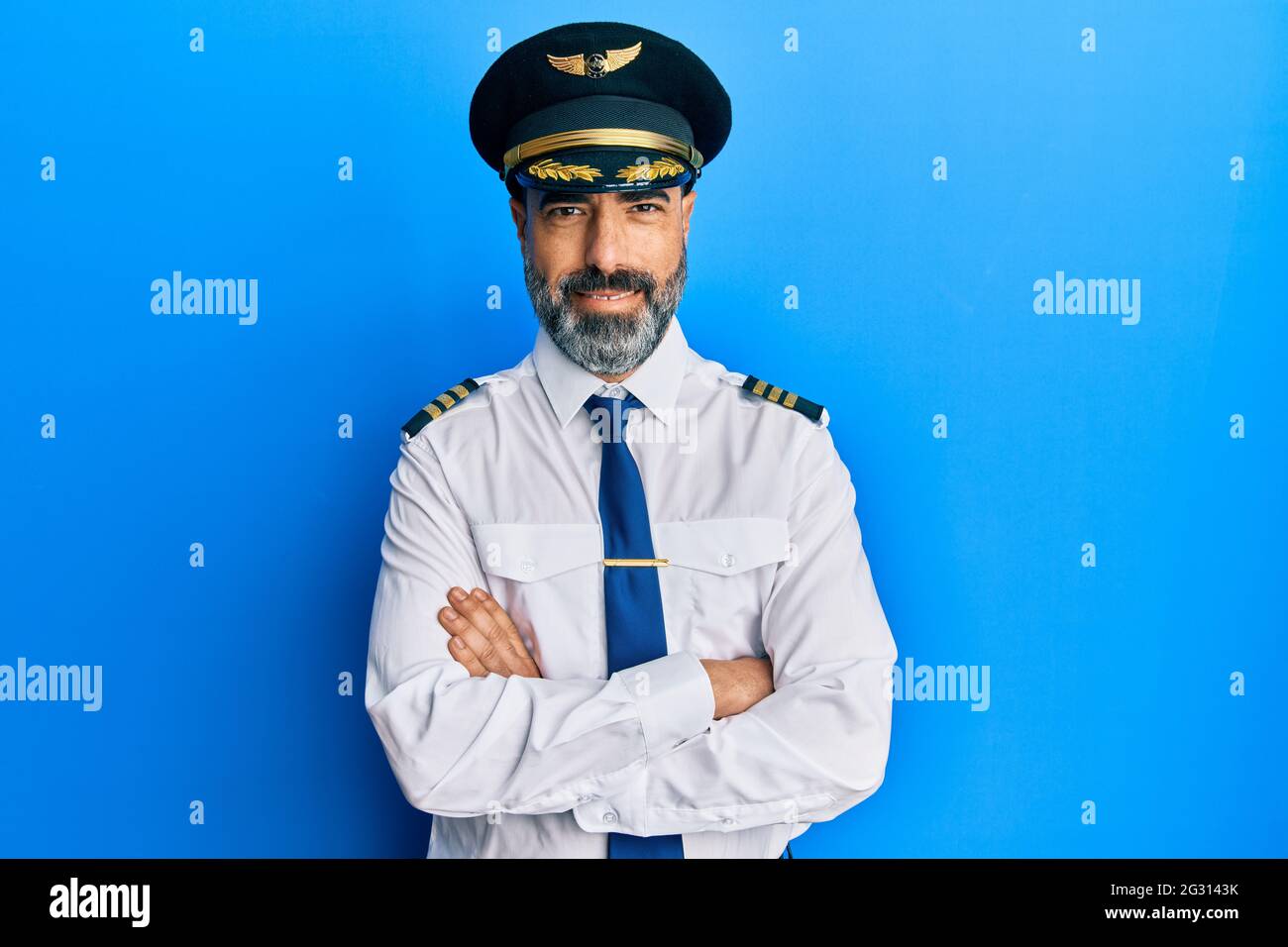 Middle age man with beard and grey hair wearing airplane pilot uniform ...