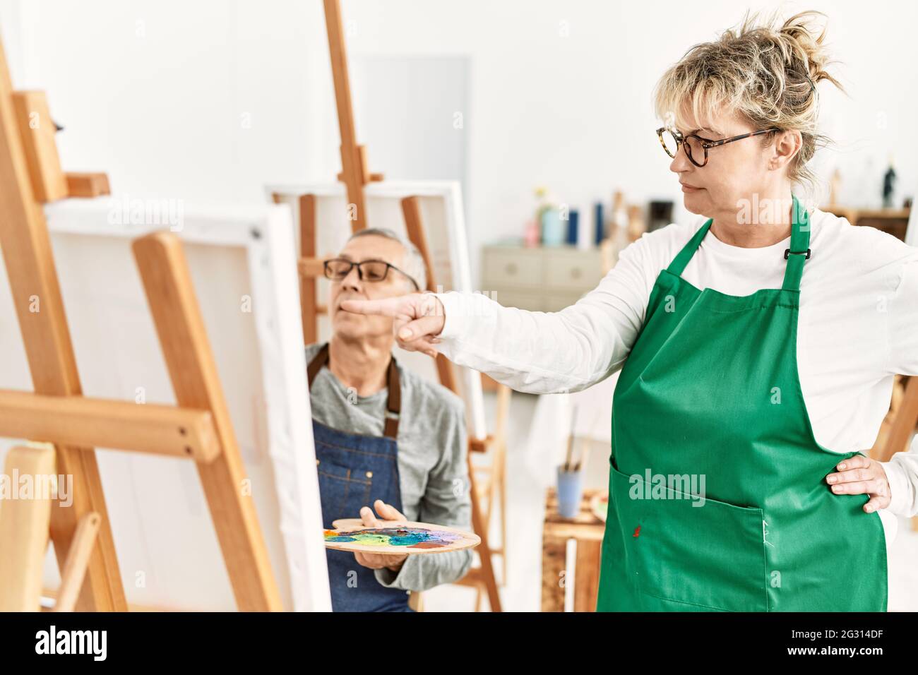 Paint teacher and student painting at art studio Stock Photo - Alamy