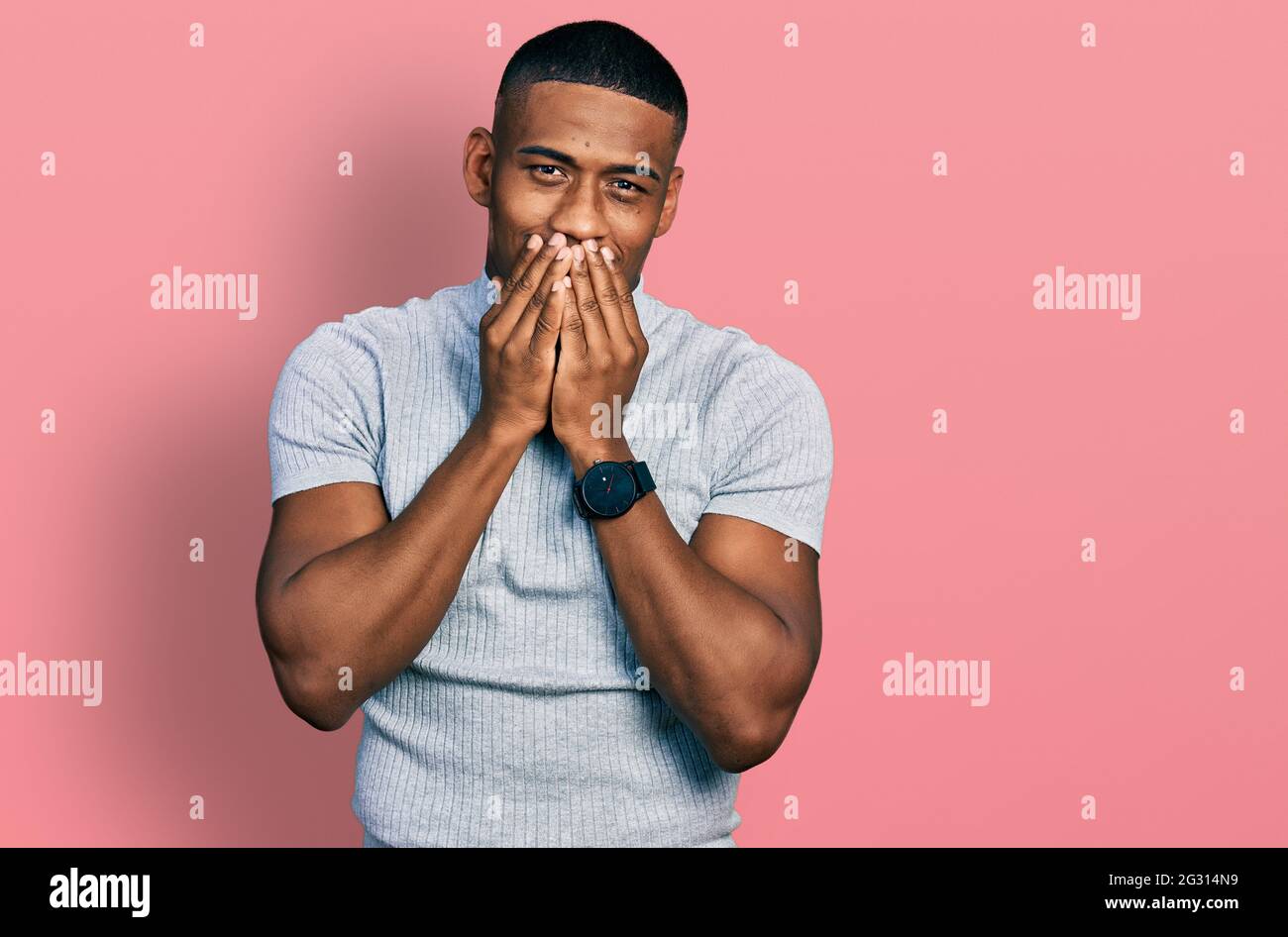 Young black man wearing casual t shirt laughing and embarrassed giggle ...