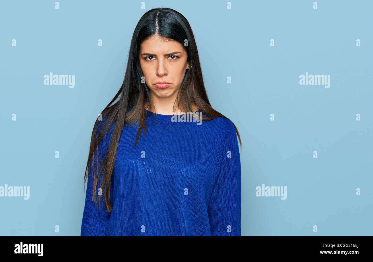 Young hispanic woman wearing casual clothes skeptic and nervous ...