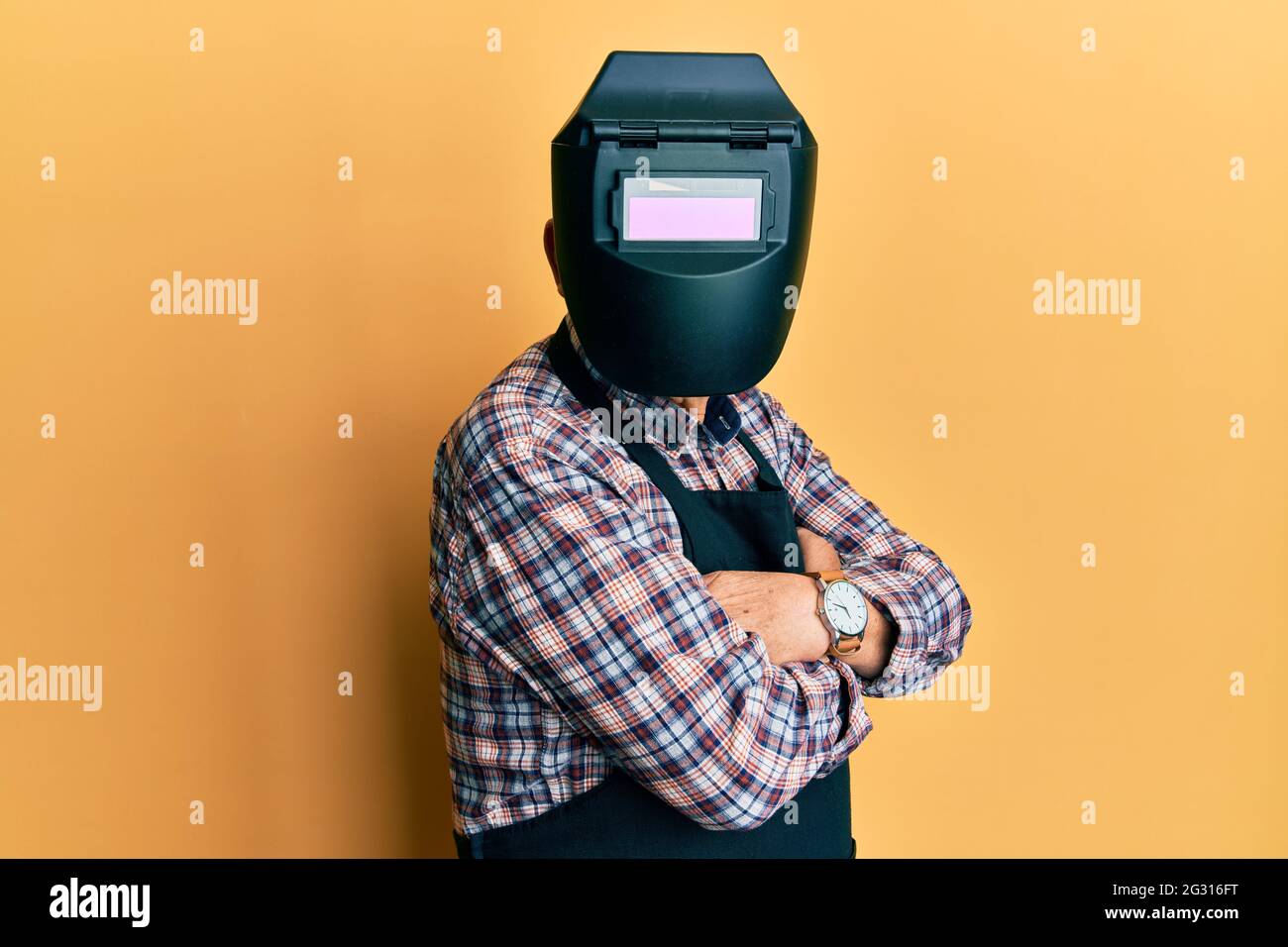 Repair man wearing professional welding mask over head covering face ...