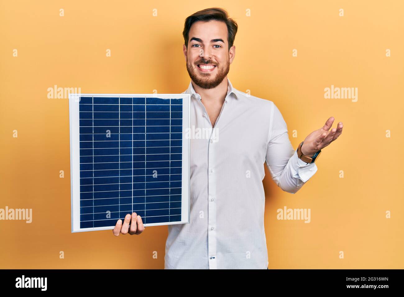 Handsome caucasian man with beard holding photovoltaic solar panel ...