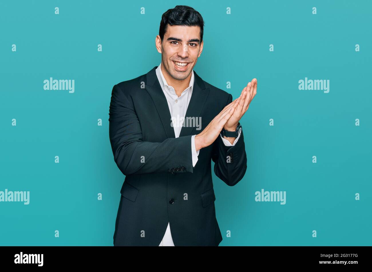 Handsome hispanic man wearing business clothes clapping and applauding ...