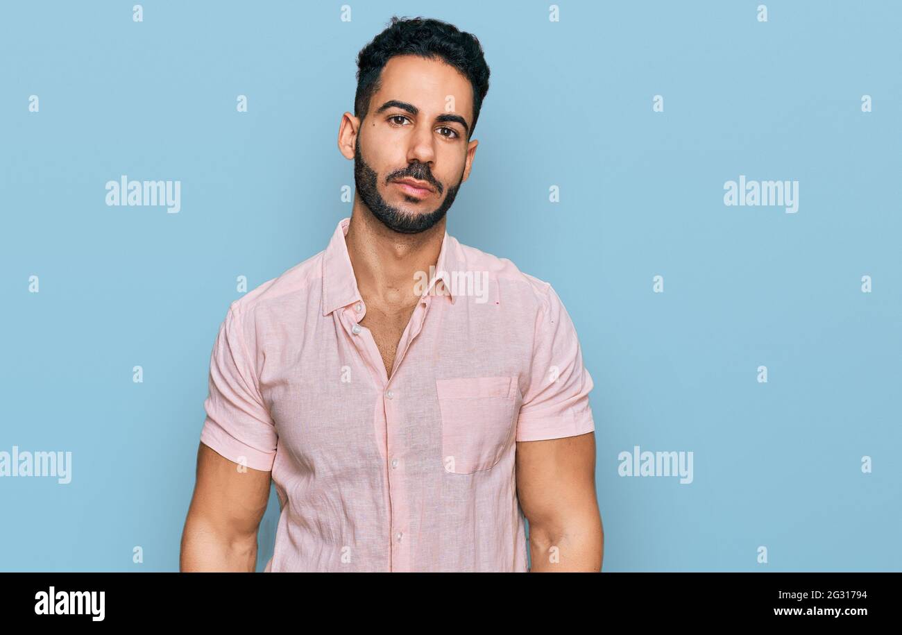 Hispanic man with beard wearing casual shirt relaxed with serious ...