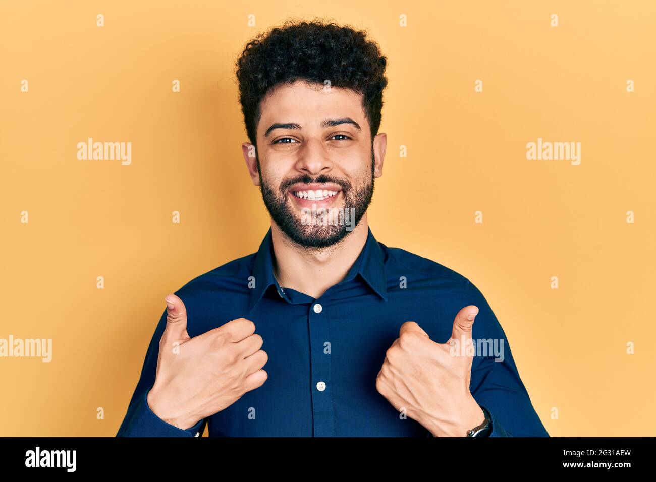 Young arab man with beard wearing casual shirt success sign doing ...