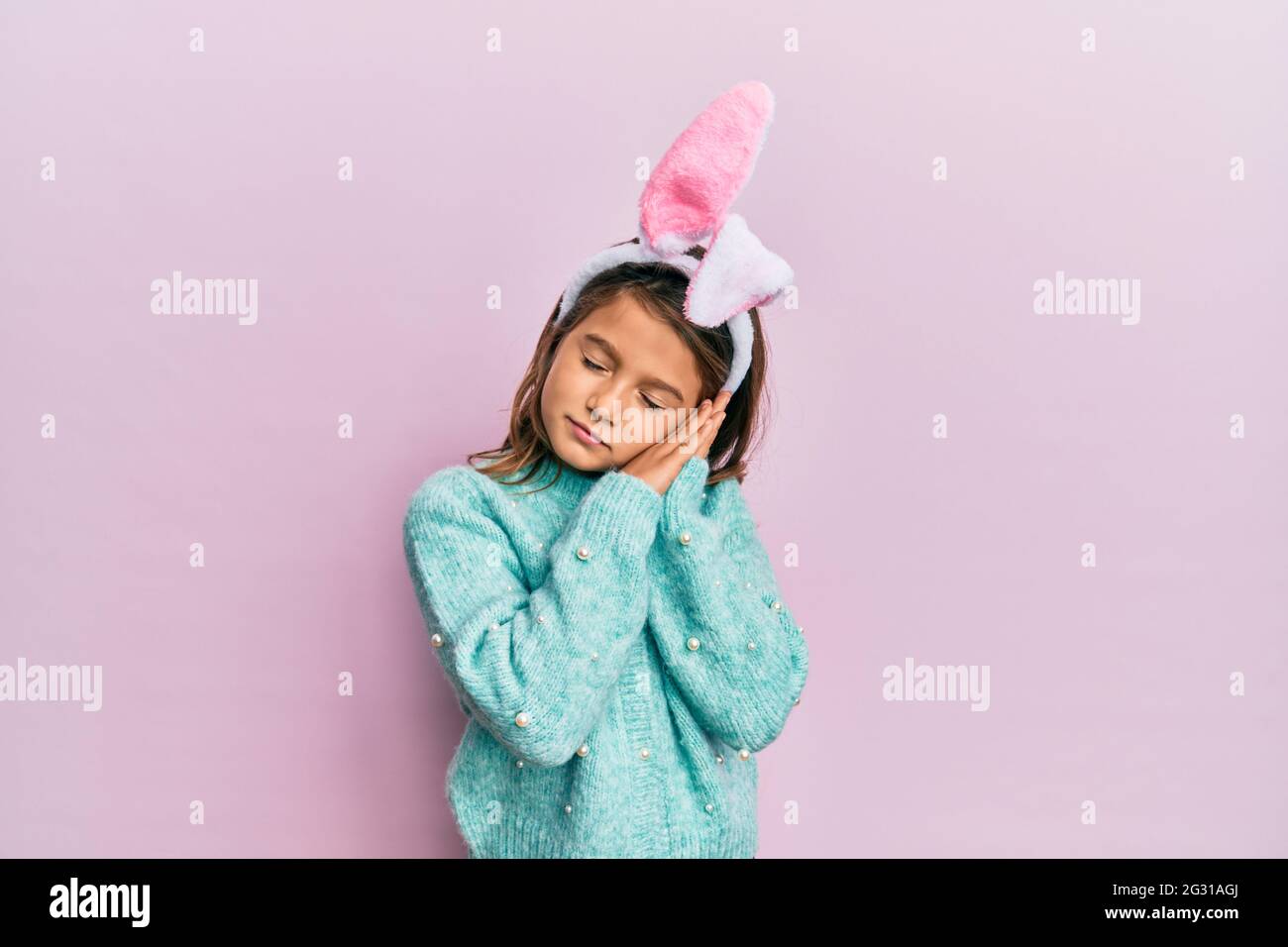 Little beautiful girl wearing cute easter bunny ears sleeping tired ...