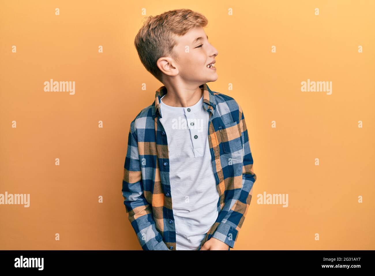 Little caucasian boy kid wearing casual clothes looking away to side ...