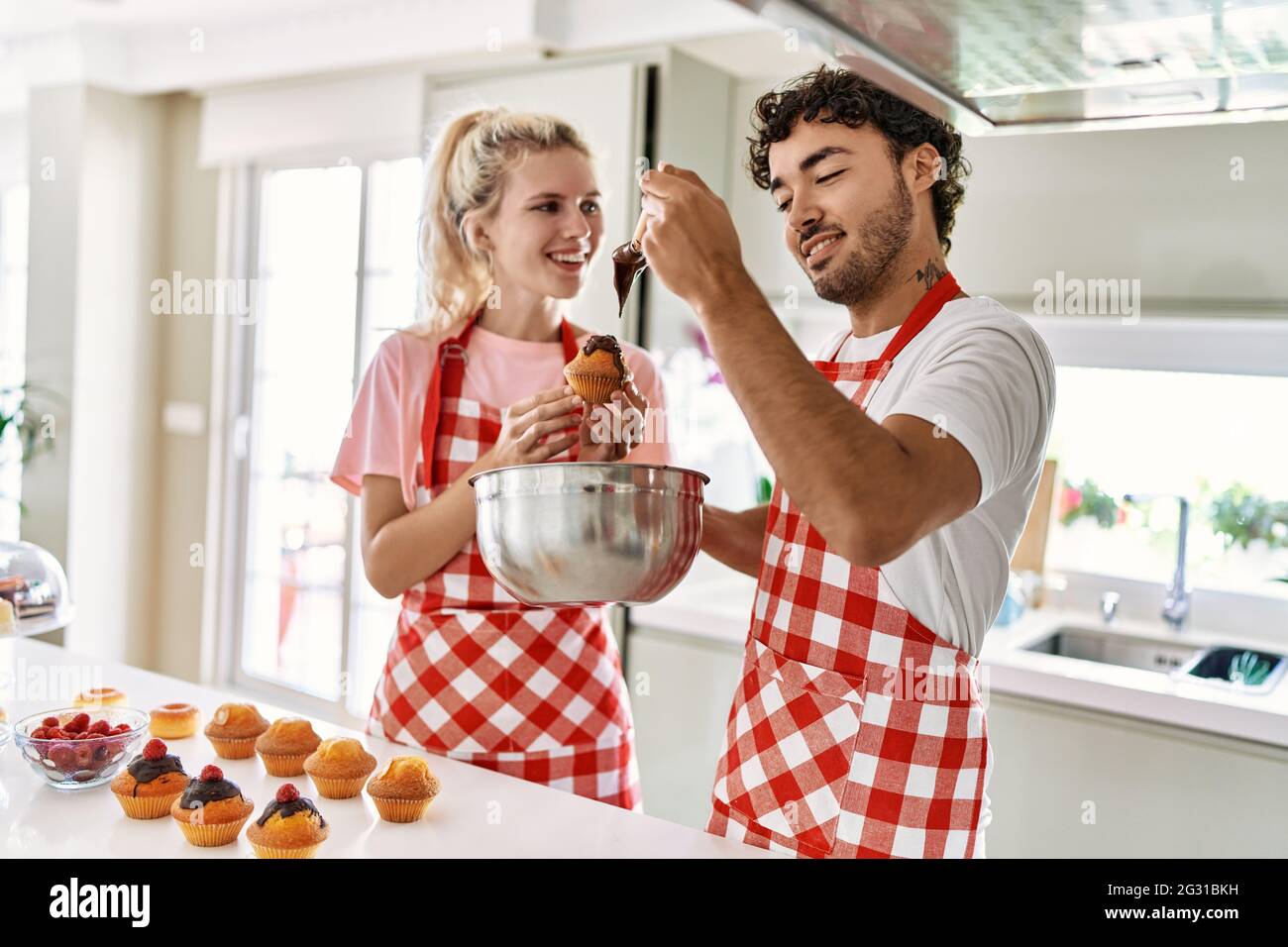 Young couple smiling happy cooking sweets at kitchen Stock Photo - Alamy