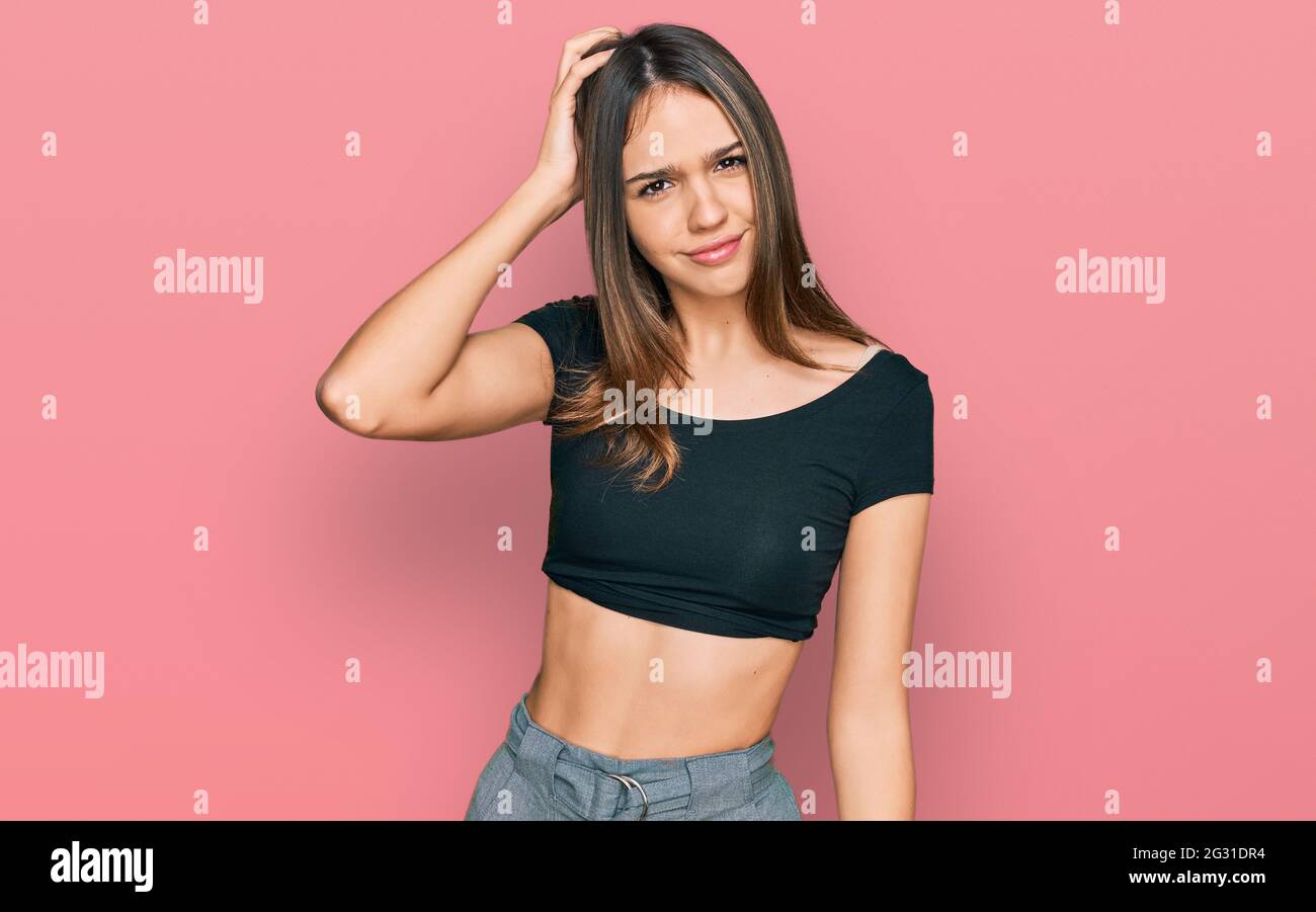 Young brunette woman wearing casual clothes confuse and wonder about ...