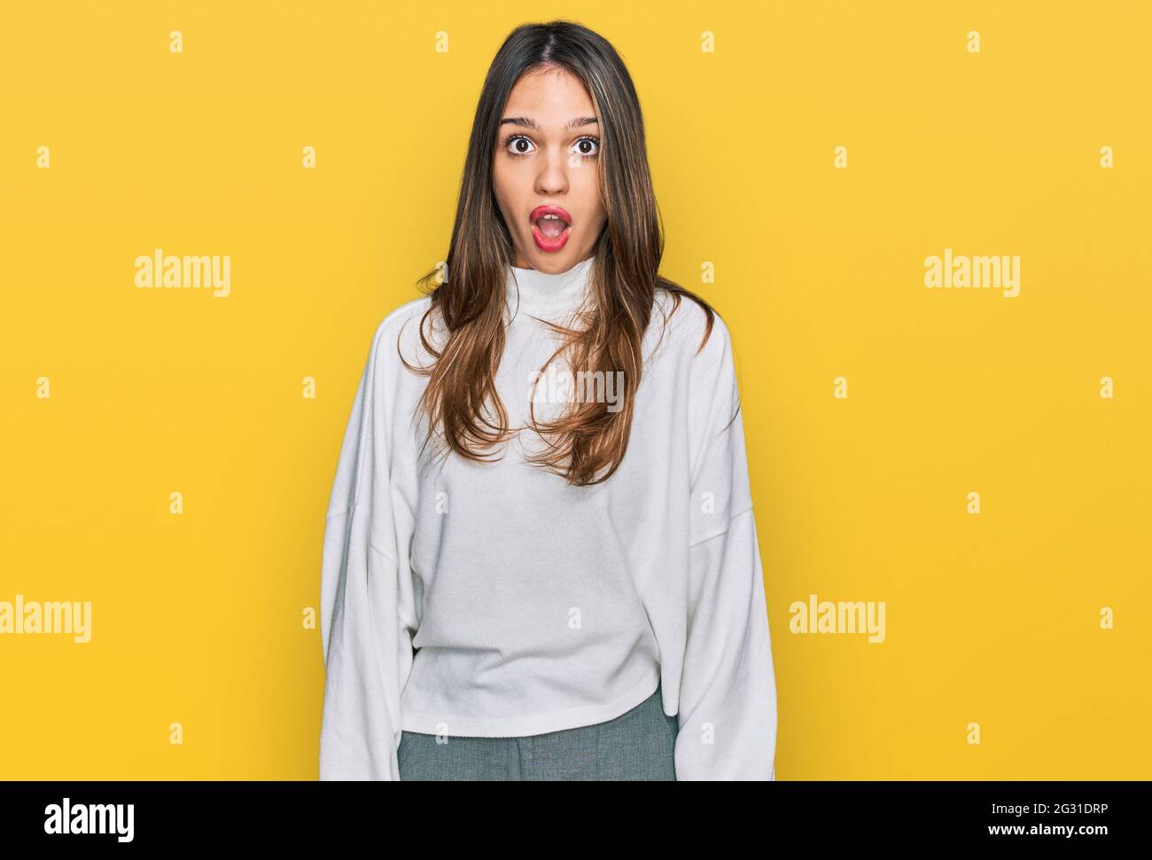 Young brunette woman wearing casual turtleneck sweater afraid and ...