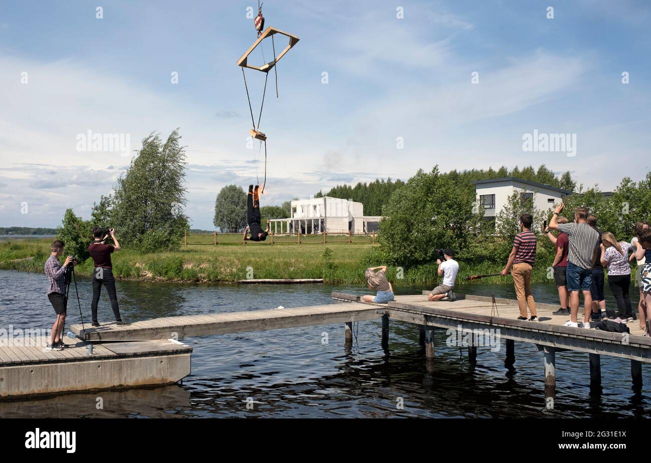 Straitjacket escape while hung upside down from a crane hi-res stock ...