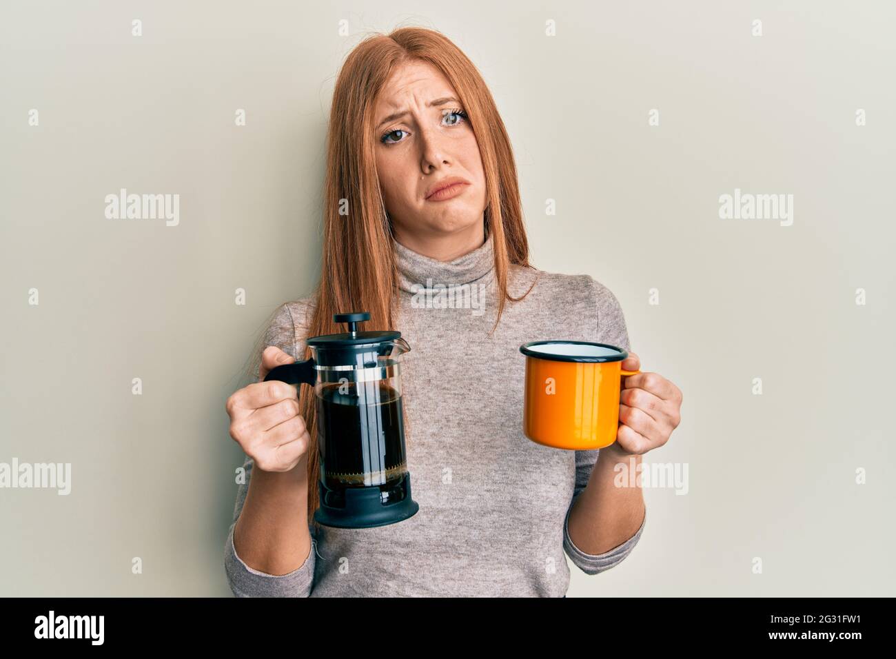 Young irish woman drinking italian coffee depressed and worry for ...