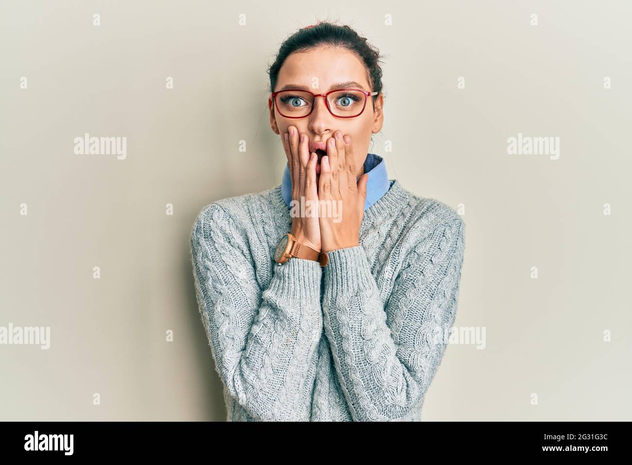Young caucasian woman wearing casual clothes and glasses afraid and ...