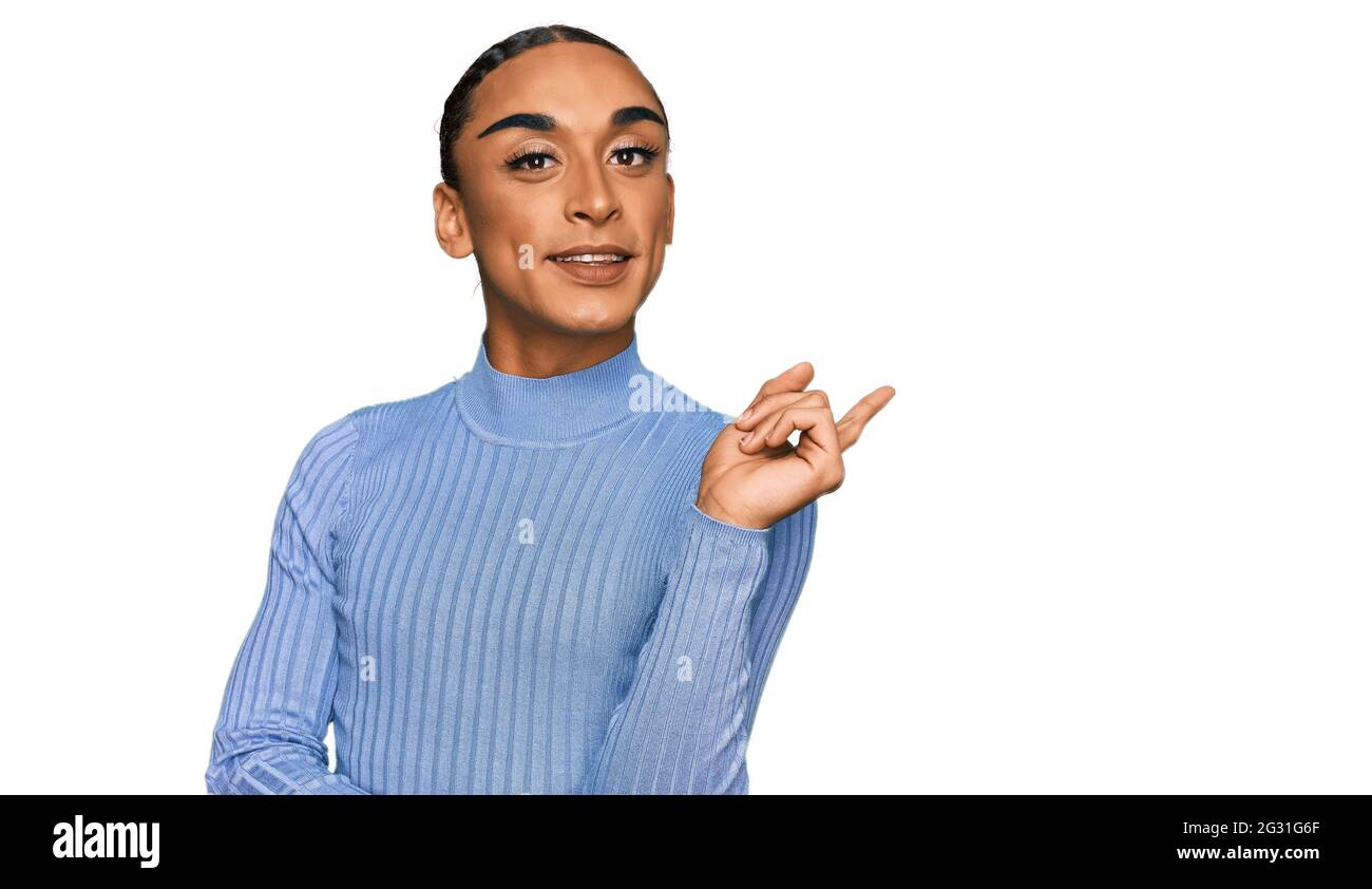 Hispanic transgender man wearing make up and long hair wearing casual ...