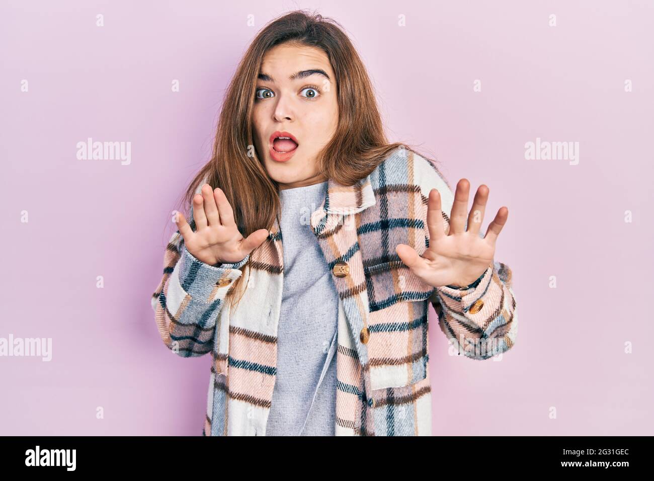 Young caucasian girl wearing casual clothes afraid and terrified with ...