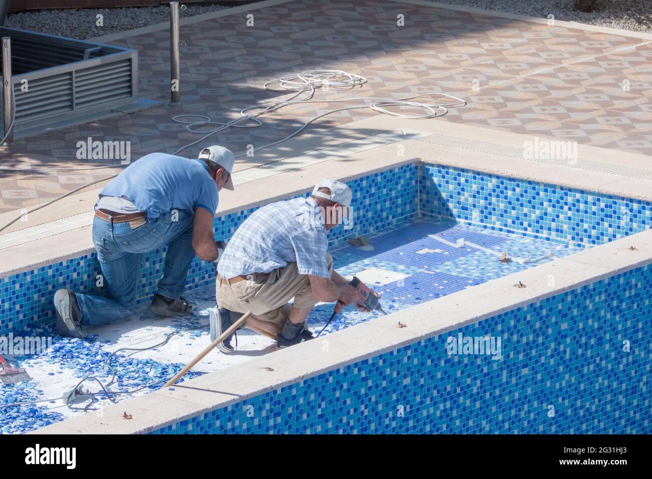 Two men working on swimming pool - Alanya, Turkey - May 18, 2021 Stock ...