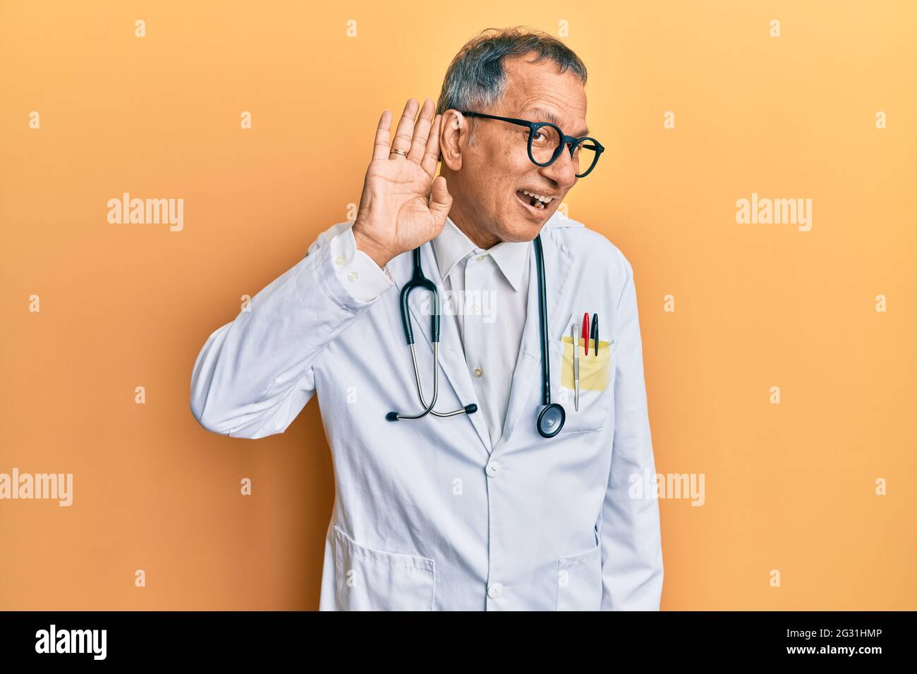 Middle age indian man wearing doctor coat and stethoscope smiling with ...
